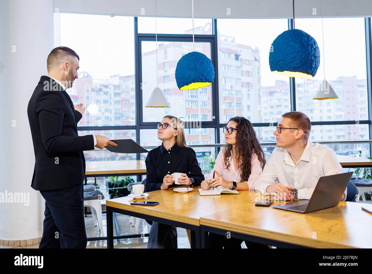 The boss stands with the charts, demonstrates statistics, various ...