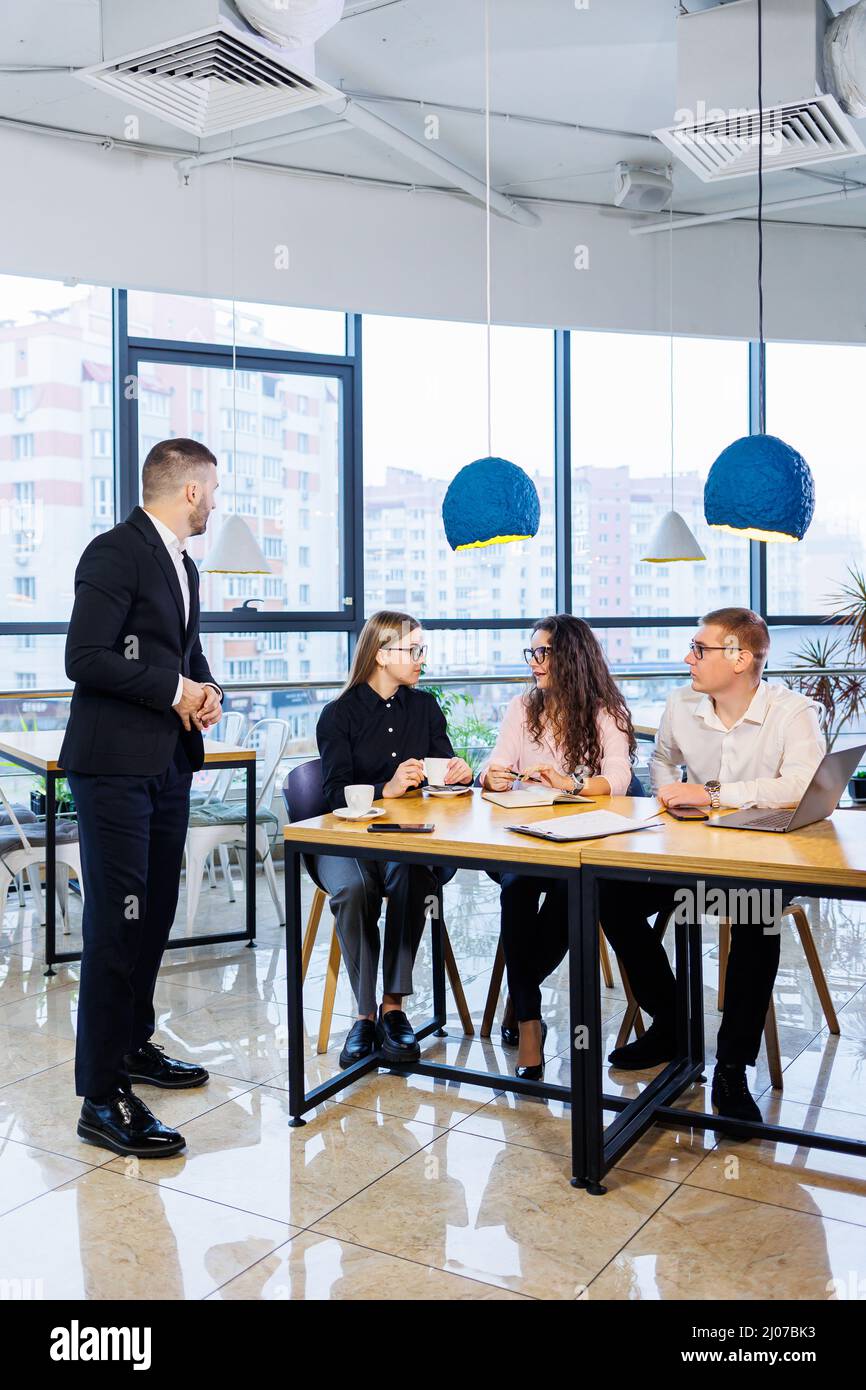 The boss stands with the charts, demonstrates statistics, various ...