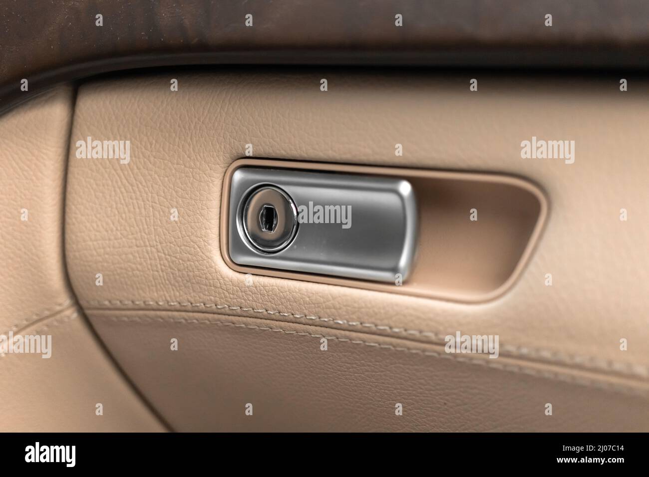Closed with key glove compartment box in luxury car with leather, close ...