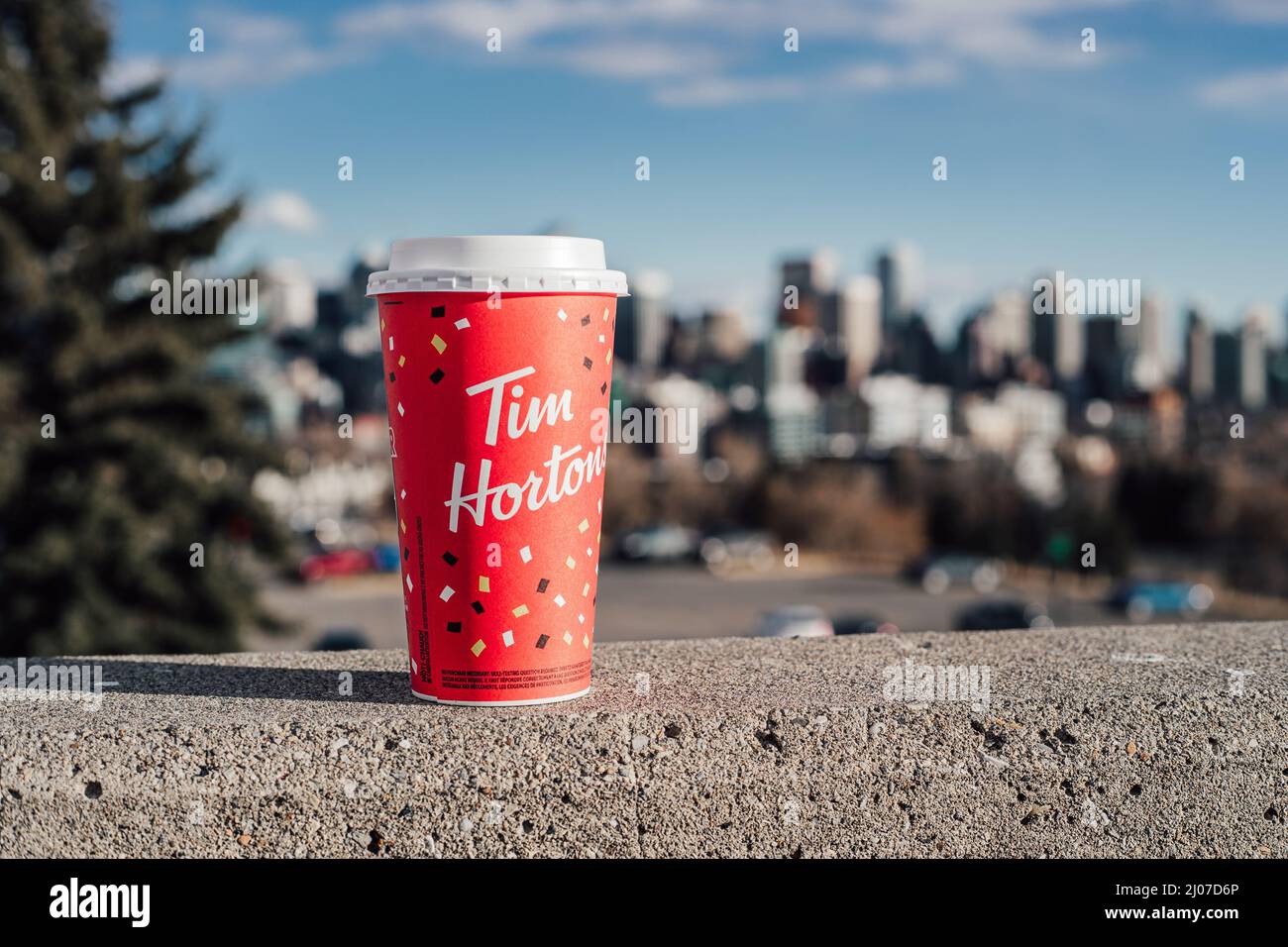Tim Hortons cup with city in background Stock Photo - Alamy