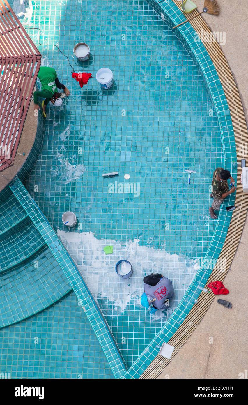Workers tiling the swimming pool Stock Photo - Alamy