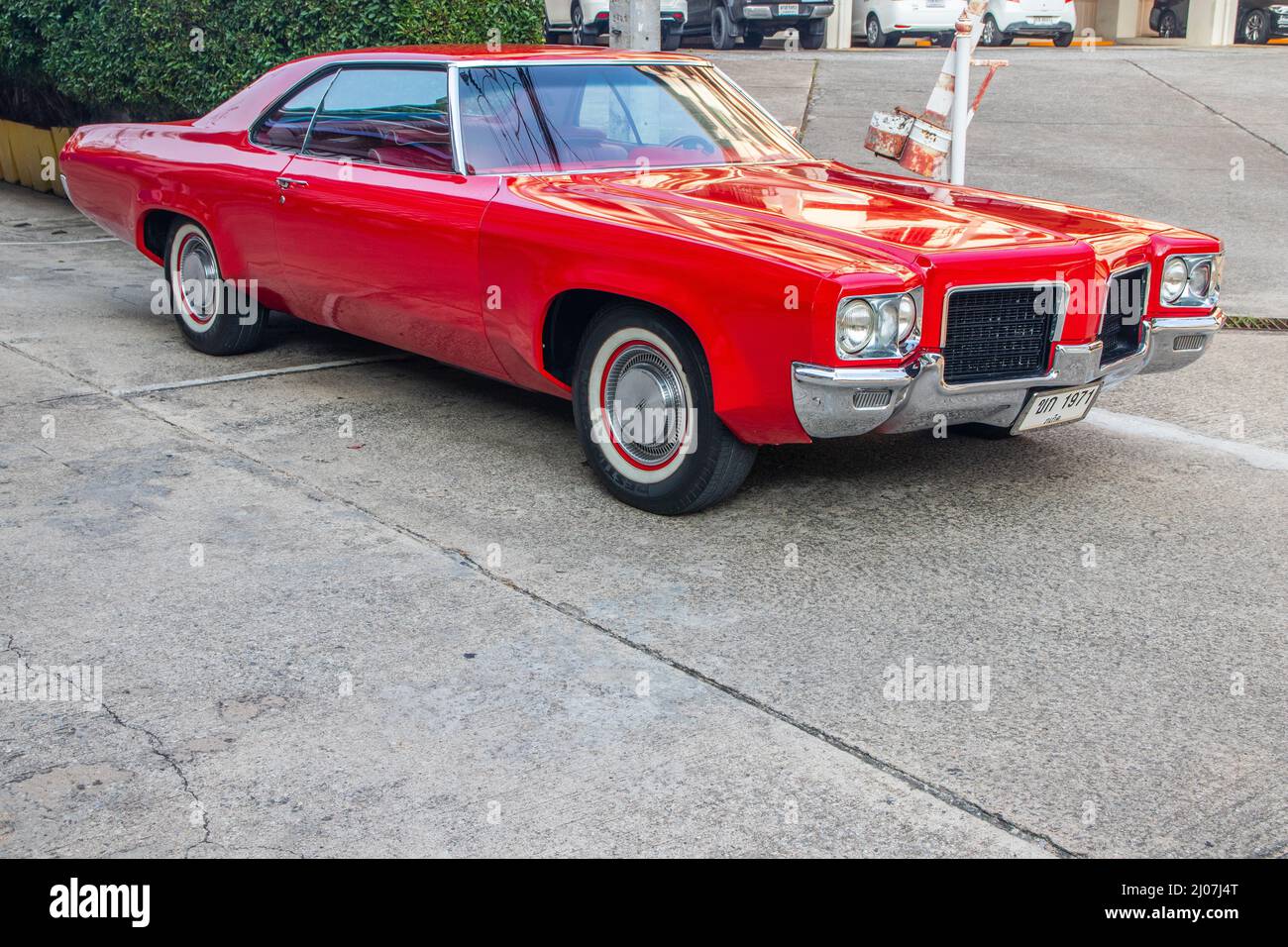 American red-painted classic car in the street Stock Photo - Alamy