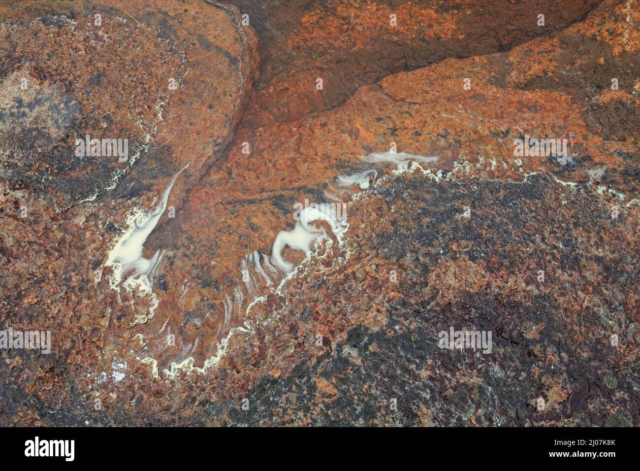 Rock with a pond and waterline Stock Photo - Alamy