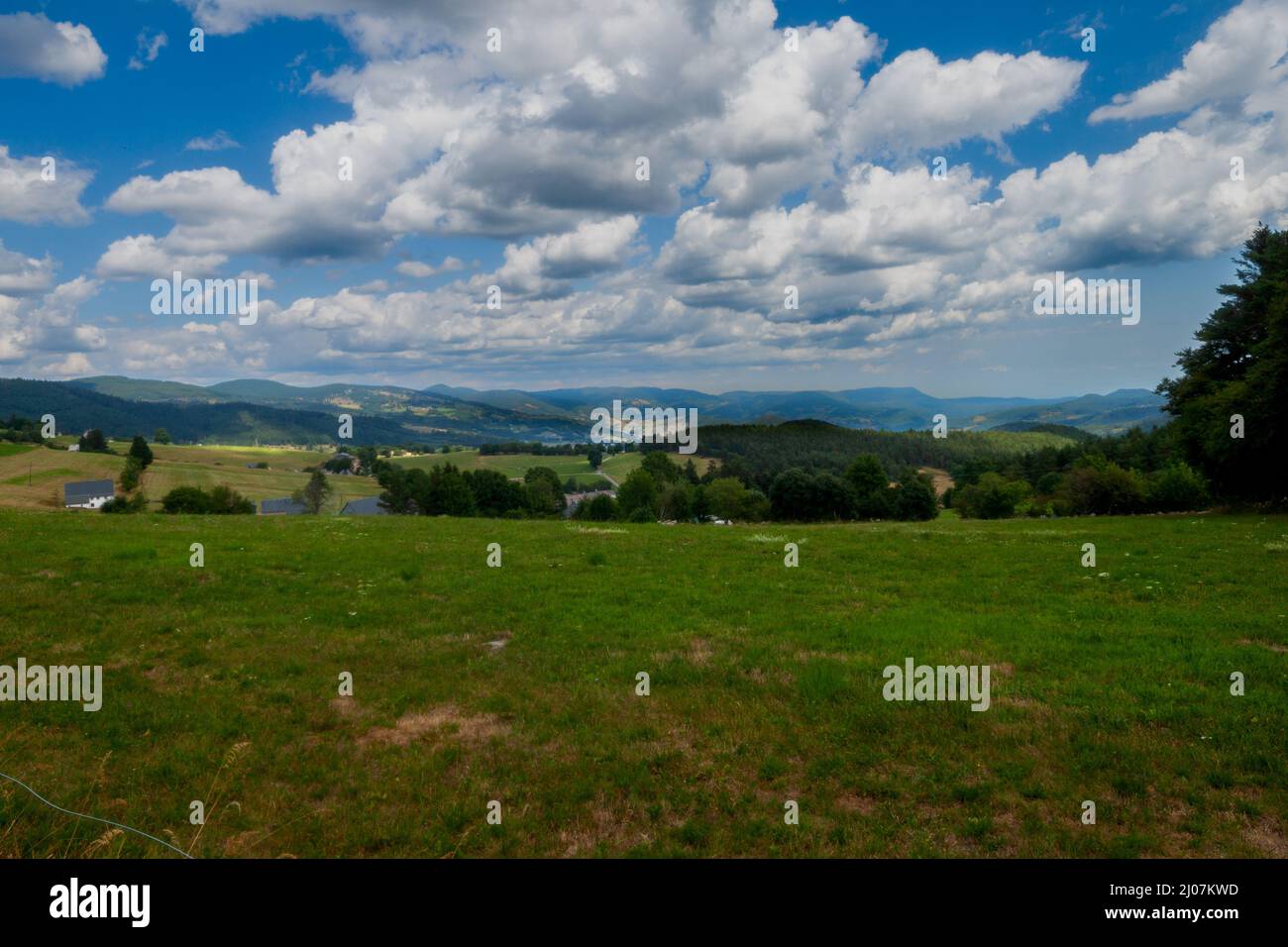 The Vosges mountains in France, with green meadows forest some clouds ...