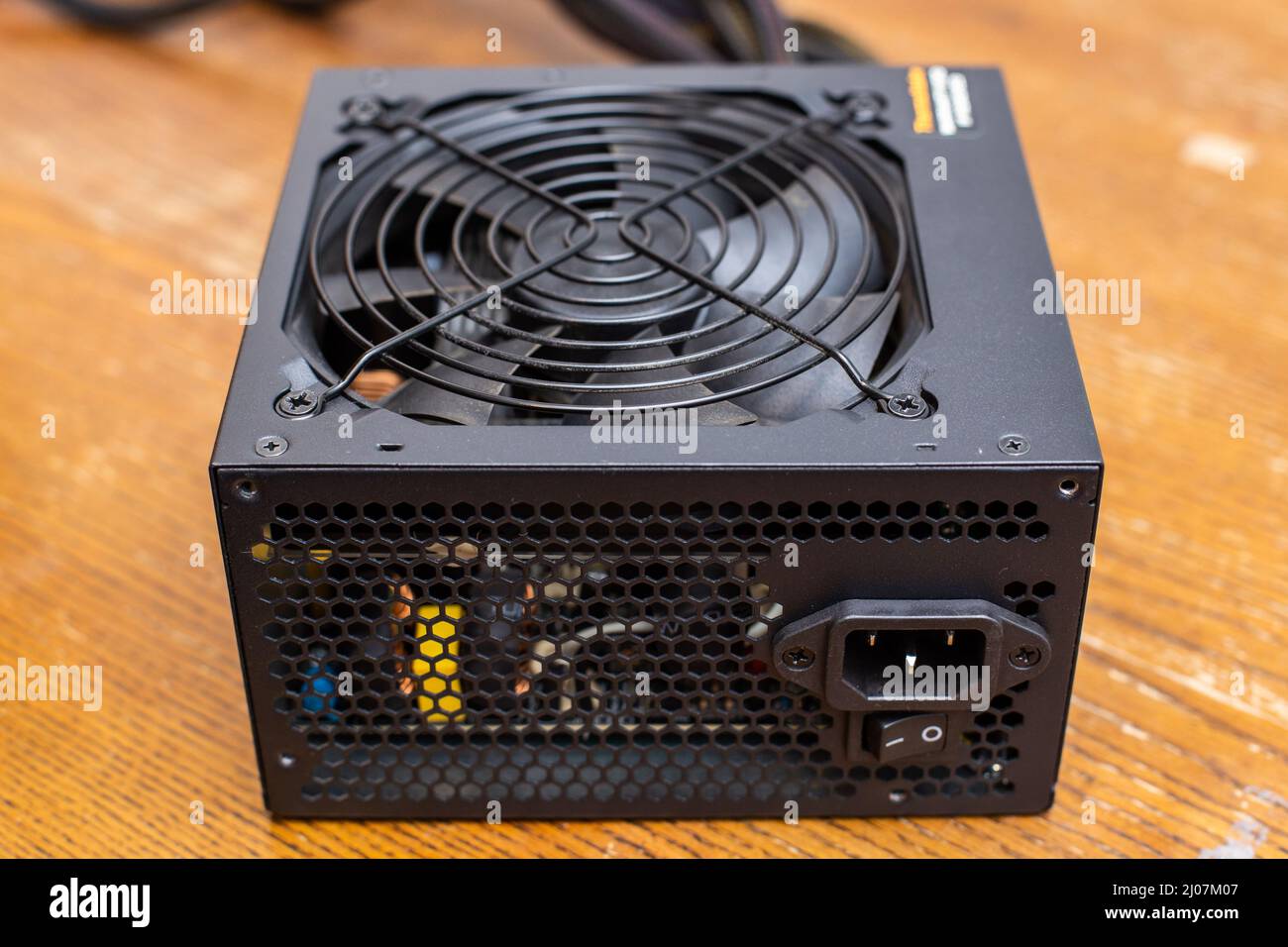 black ATX PC power supply unit on wooden surface Stock Photo - Alamy