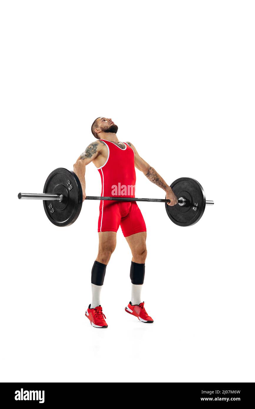Full length portrait of man in red sportswear exercising with a weight ...