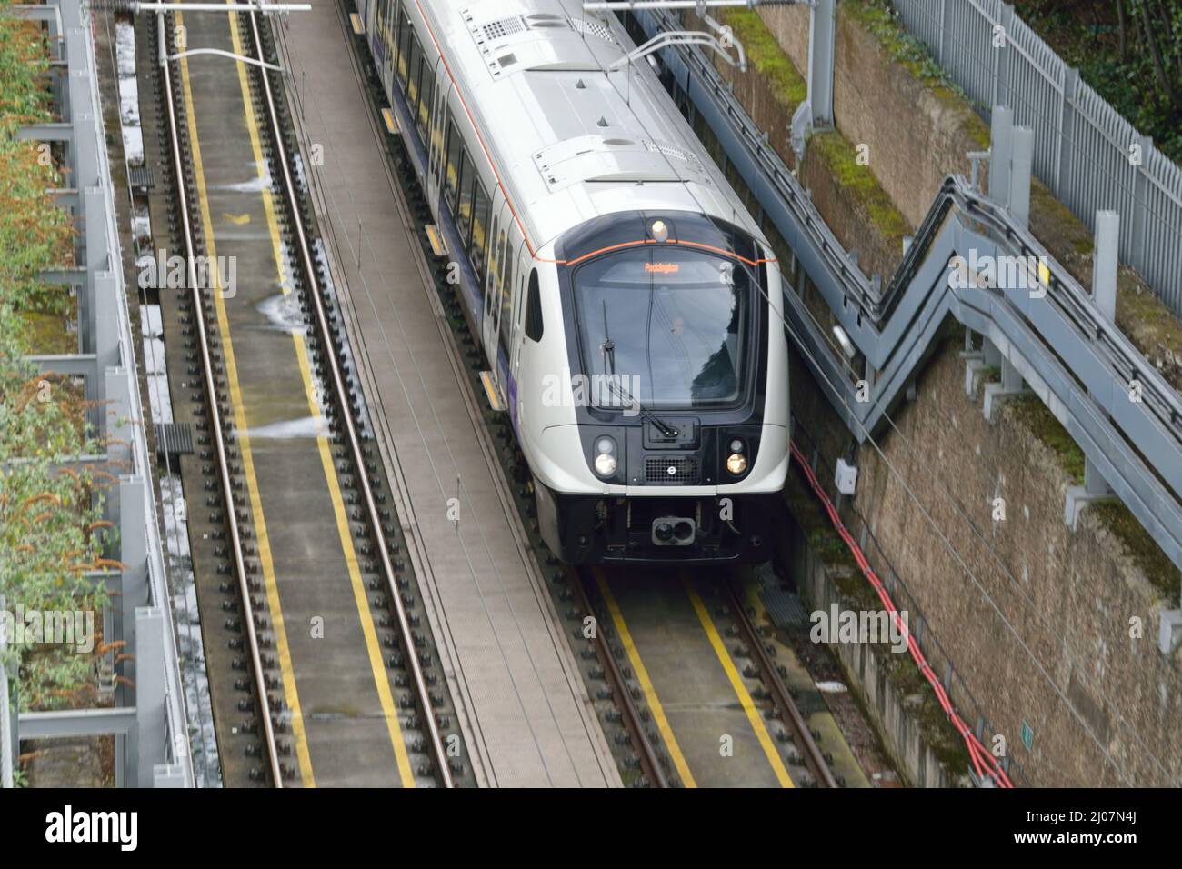 Westbound Elizabeth Line (Crossrail) Class 345 train emerging from the Connaught Tunnel in East ...