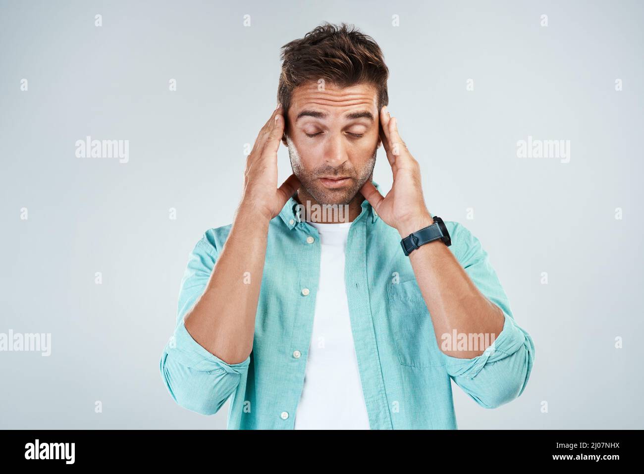 I cant concentrate properly. Studio shot of a young man with an ...
