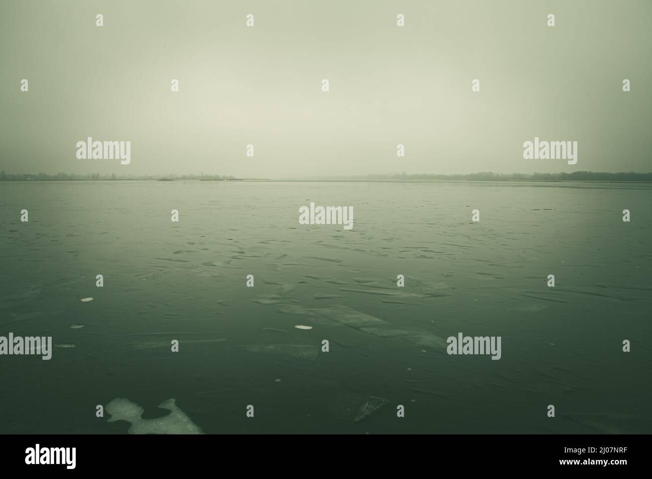 Frozen lake, dark depressing winter landscape Stock Photo - Alamy