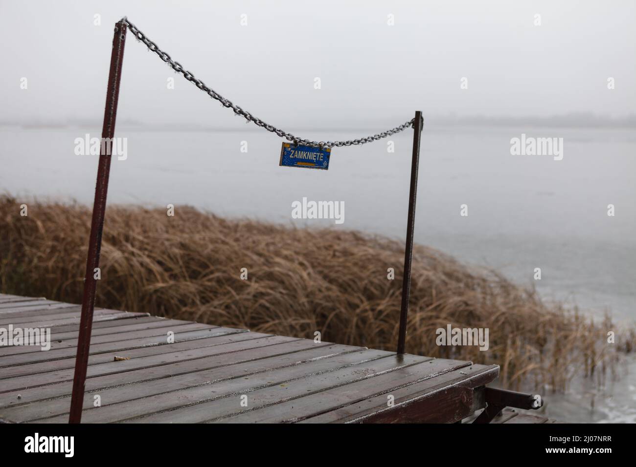 Frozen lake and closed bridge, dark depressing winter landscape Stock ...