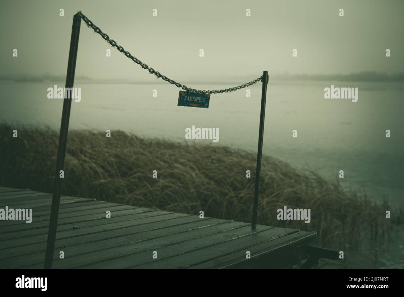 Frozen lake and closed bridge, dark depressing winter landscape Stock ...