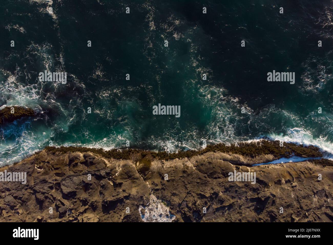 Aerial top view of raging ocean waves and fantastic rocky coast ...