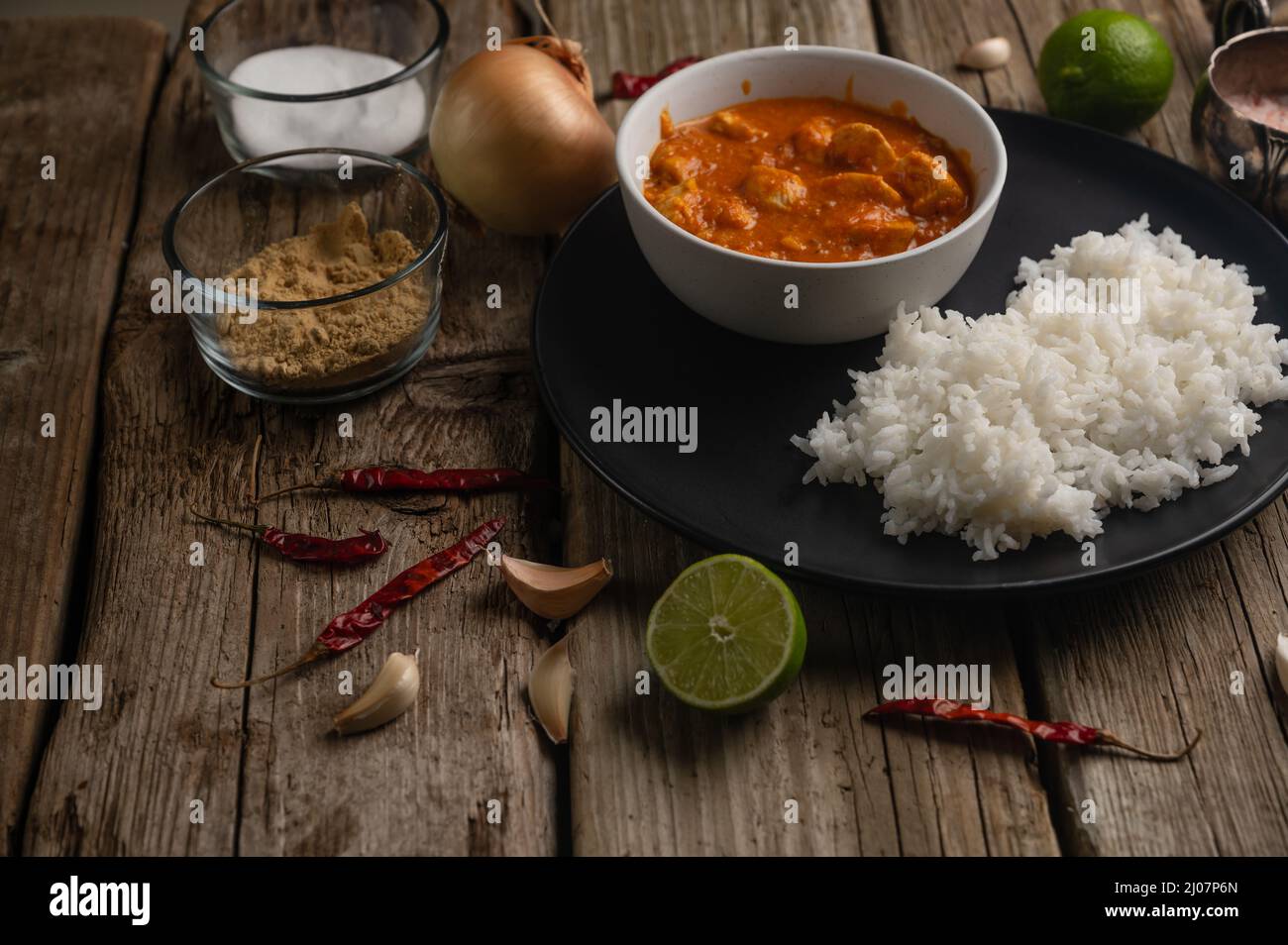 Side view of plate with delicious chicken tikka masala curry and rice ...