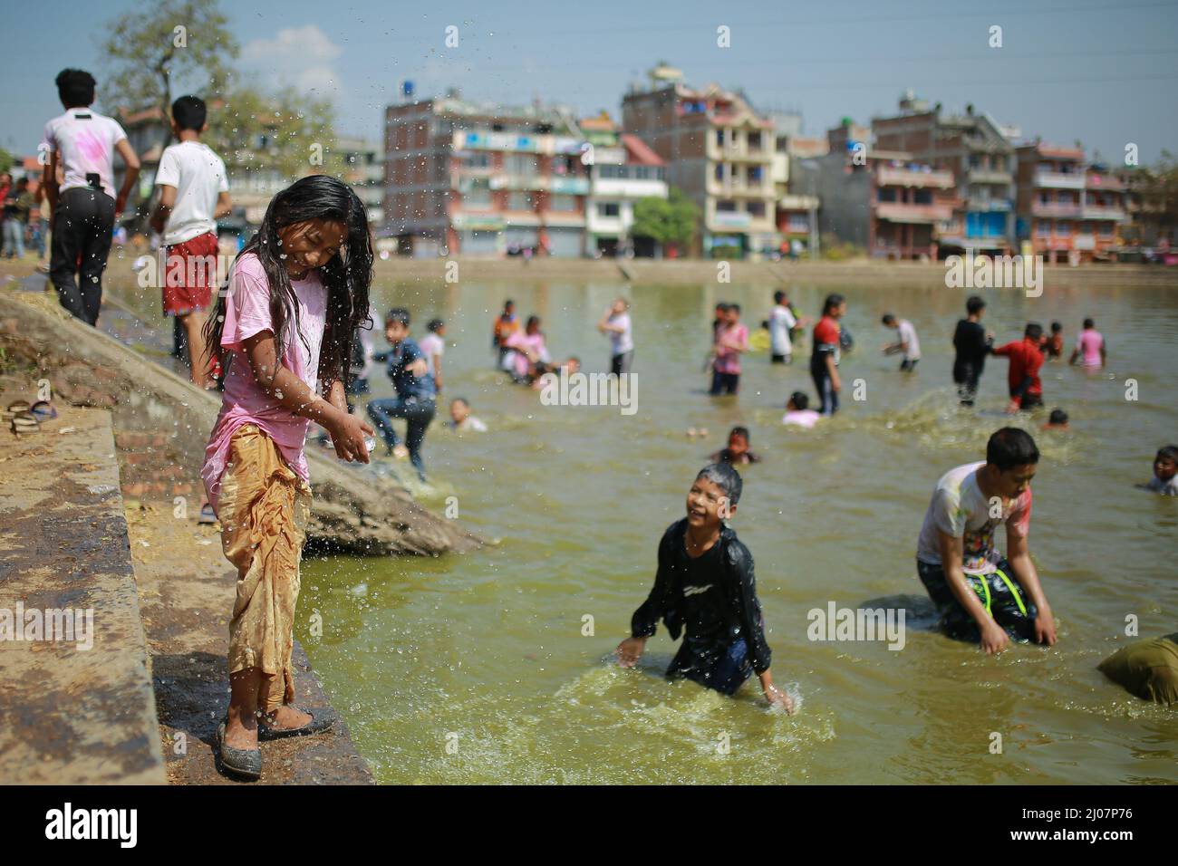 Bhaktapur, Bagmati, Nepal. 17th Mar, 2022. Kids swim in a local pond ...
