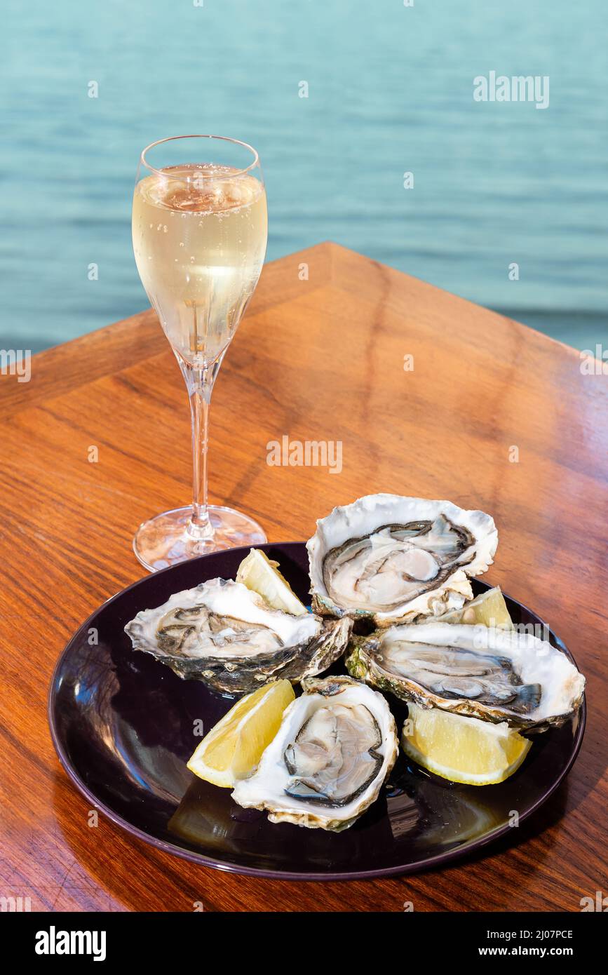 Oysters with champagne near the seashore focus on oysters Stock Photo ...