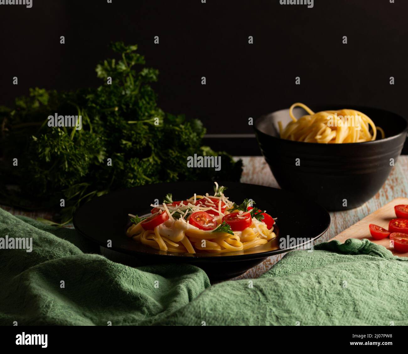 A delicious plate of creamy spaghetti topped with fresh cherry tomatoes ...