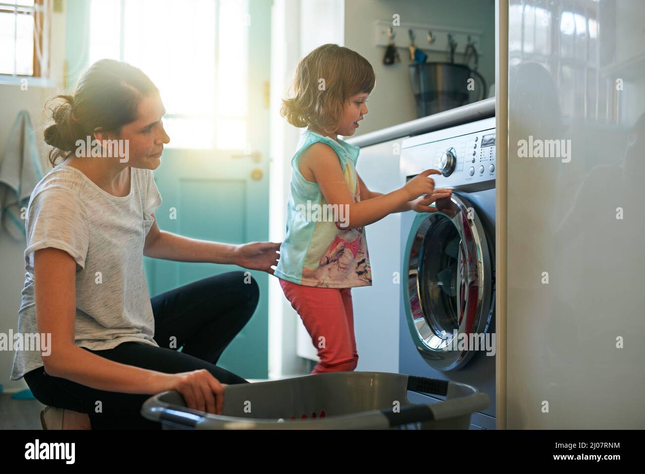 She knows which buttons to press. Shot of a mother and daughter using a ...