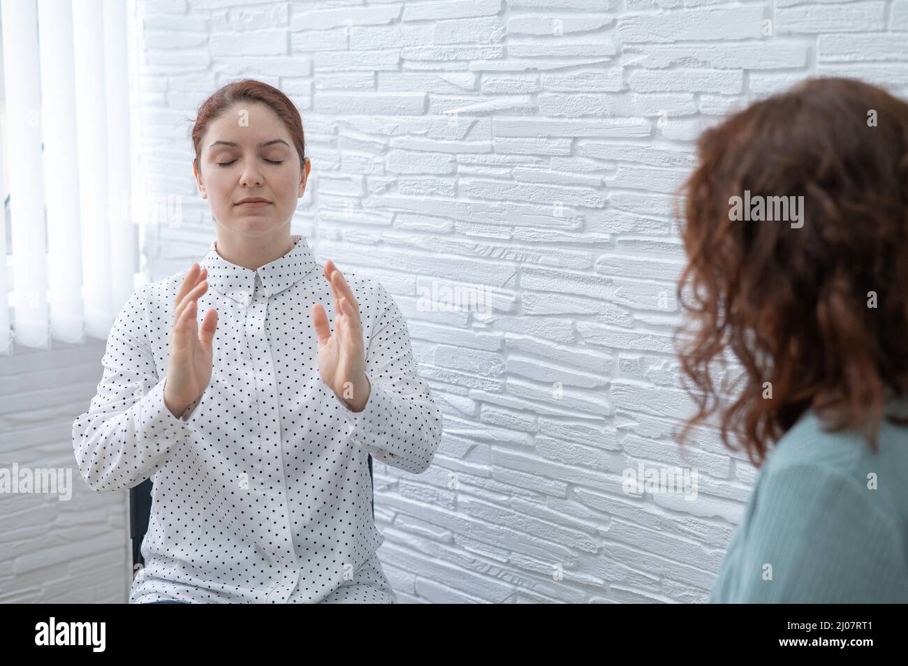 The psychotherapist conducts a hypnosis session. Female patient under ...