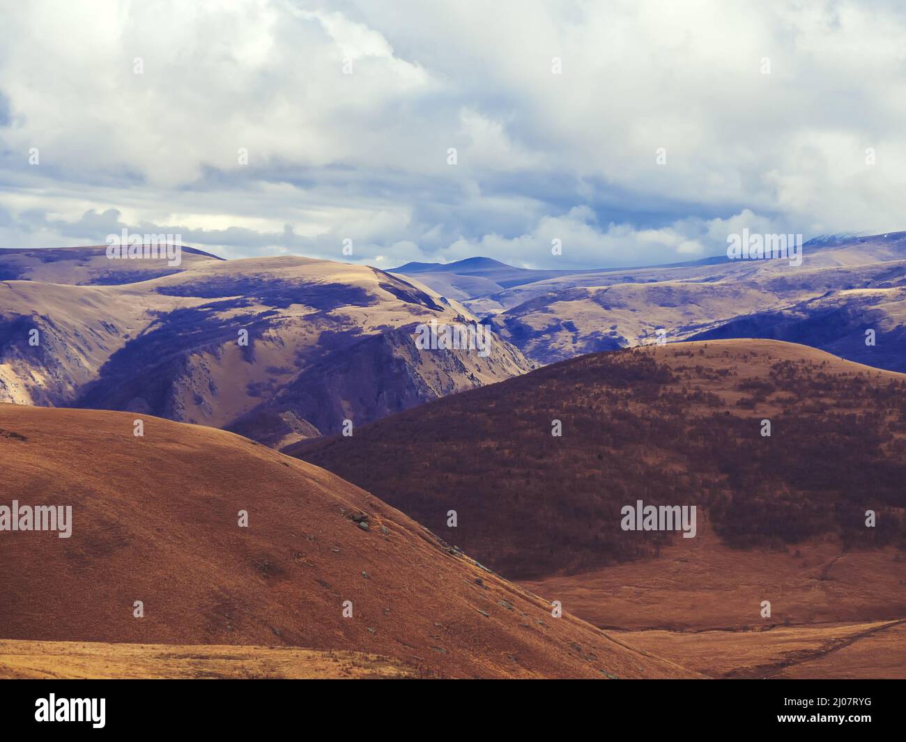 Smooth and rocky autumn Caucasian mountains under cloudy sky. Country ...
