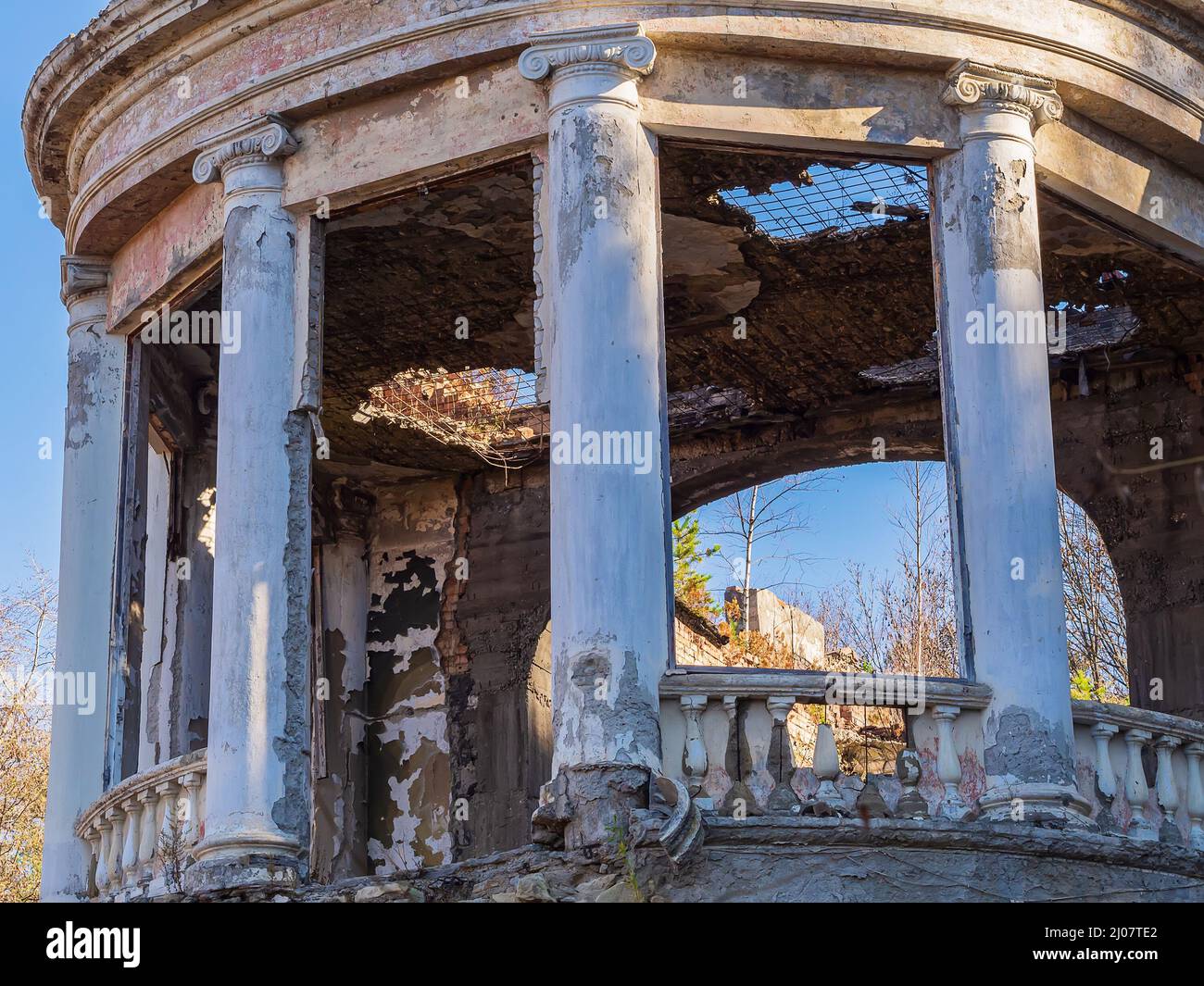 Semicircular fragment of abandoned ruined restaurant with columns and ...