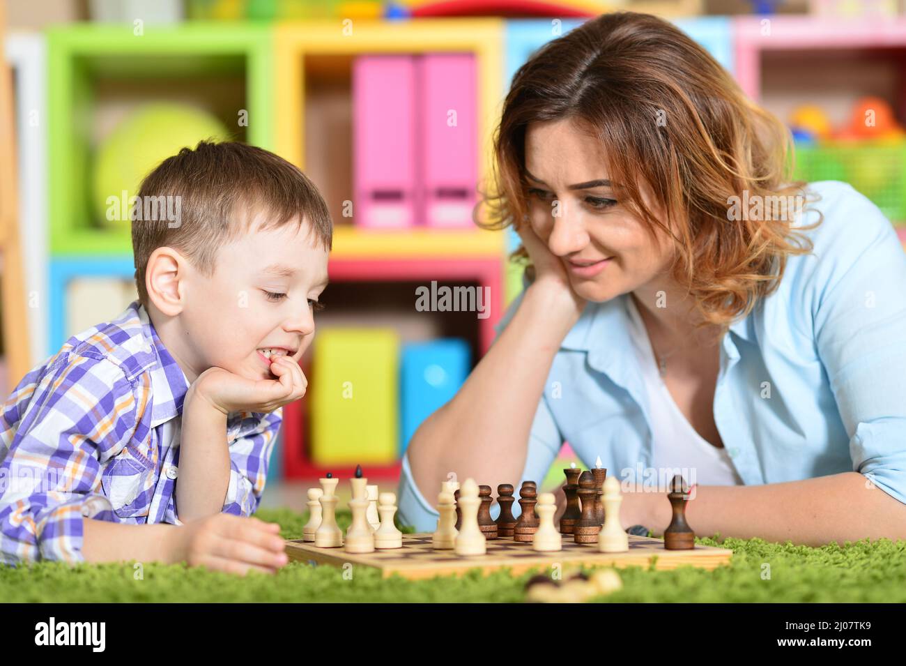 Portrait of mother with son playing chess at home Stock Photo - Alamy