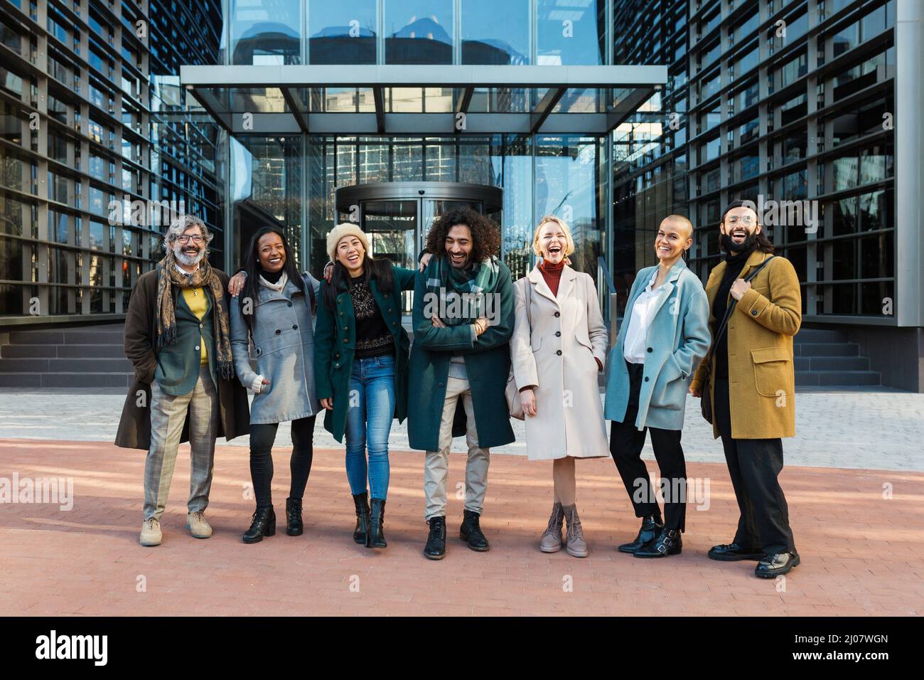 Professional business people laughing and having fun while standing ...