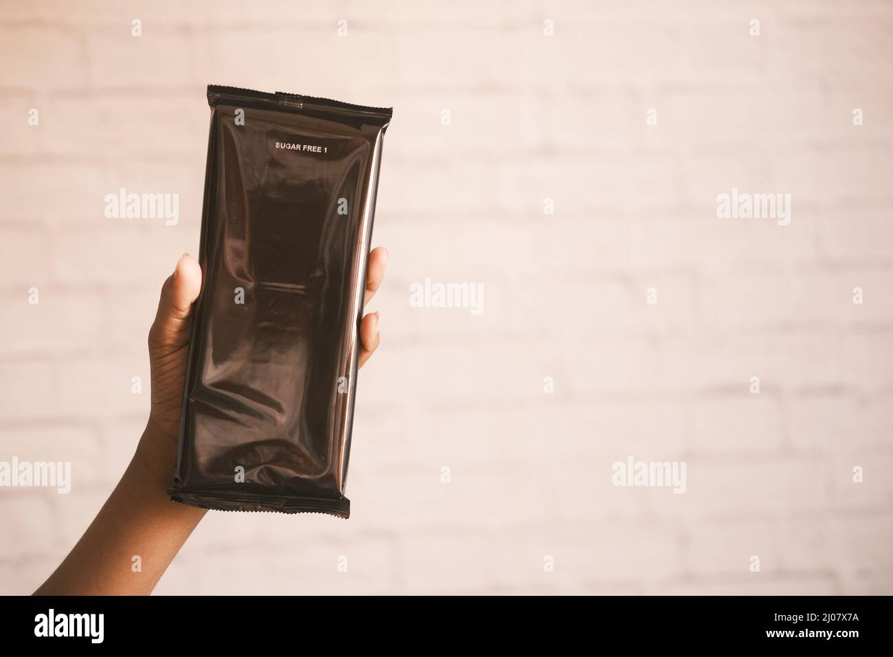 holding sugar free dark chocolate packet Stock Photo - Alamy