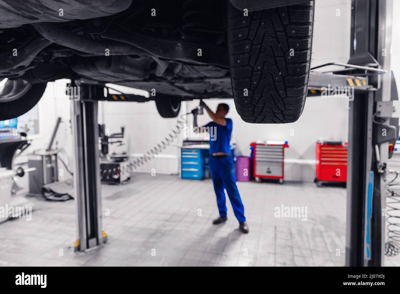 Mechanic working on checking and service car in workshop garage, engine ...
