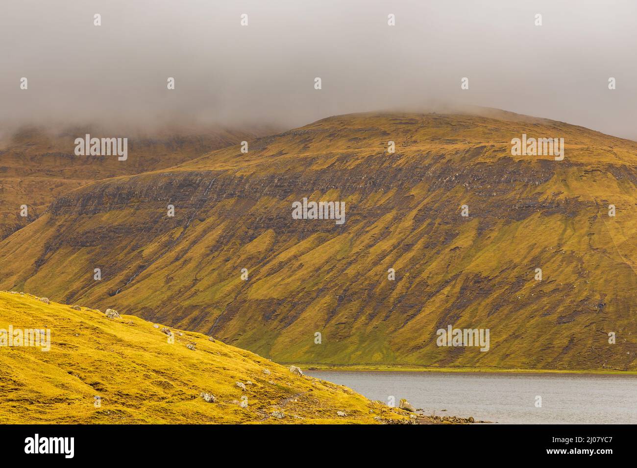Mountain landscape on the island of Streymoy. Cloudy spring day. Leynar ...
