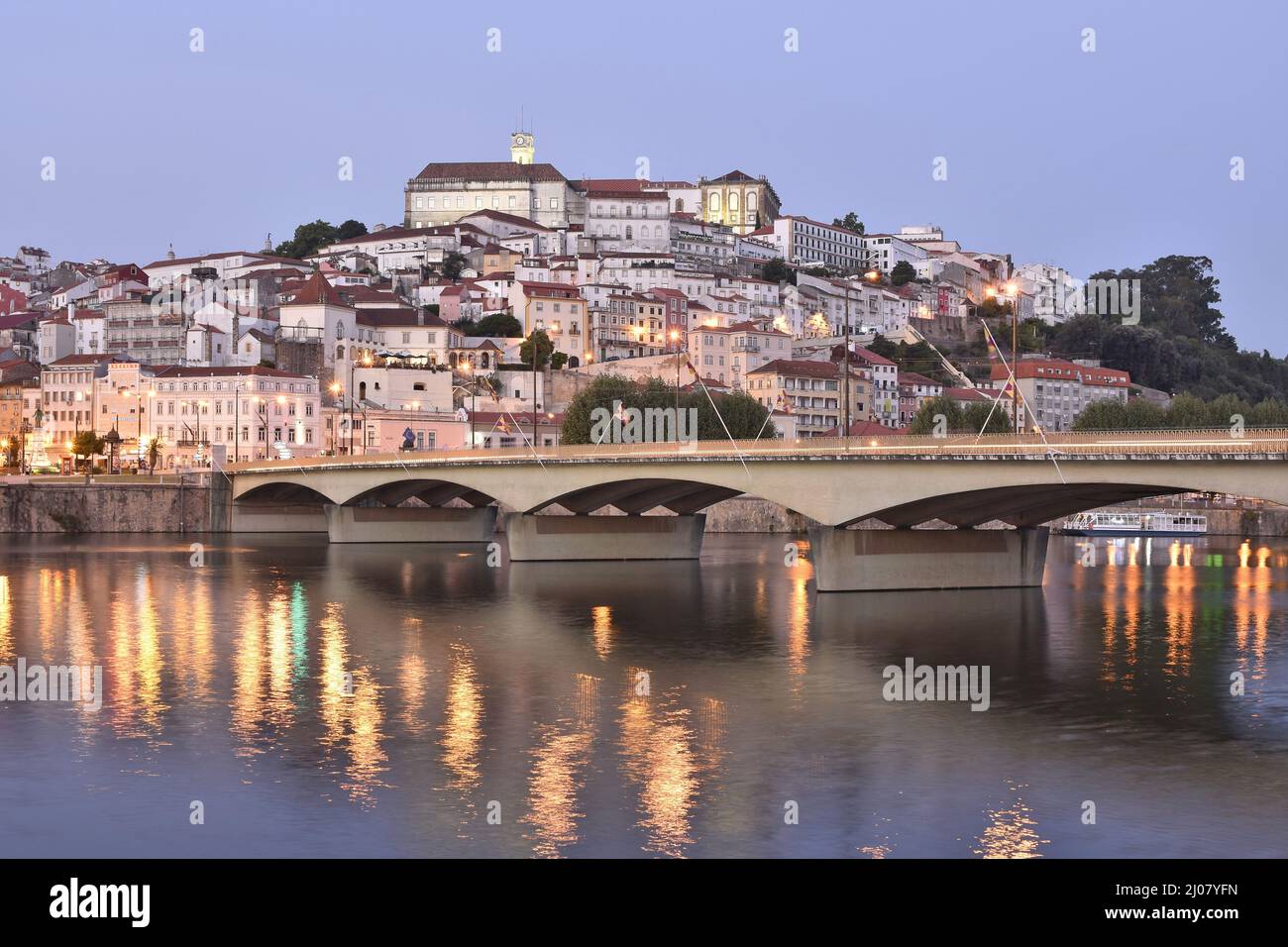 Ponte de Santa Clara bridge over river Mondego at dusk and old town ...