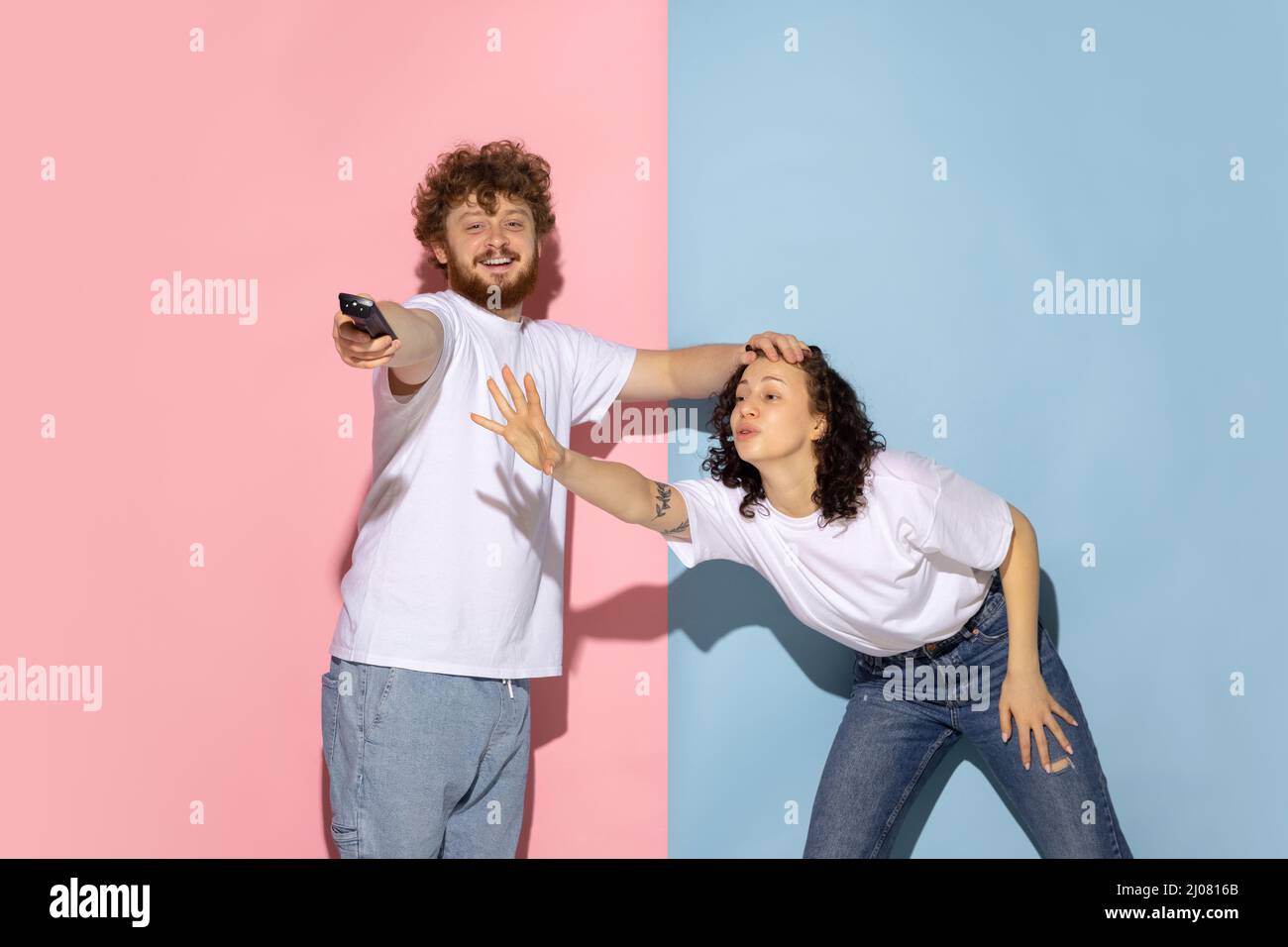 Married couple, young emotive man and girl isolated on blue and pink ...