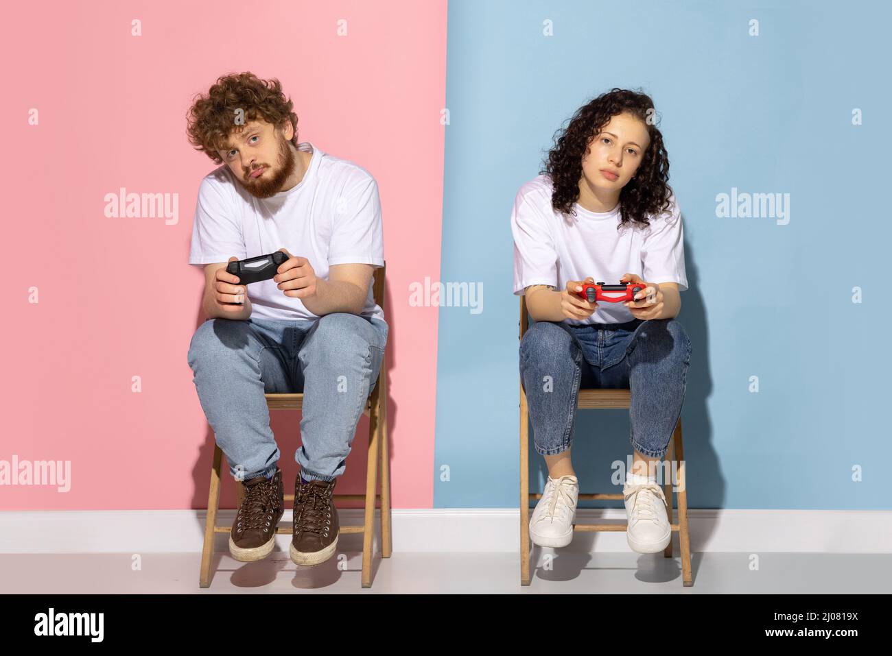 Married couple, young emotive man and girl isolated on blue and pink ...