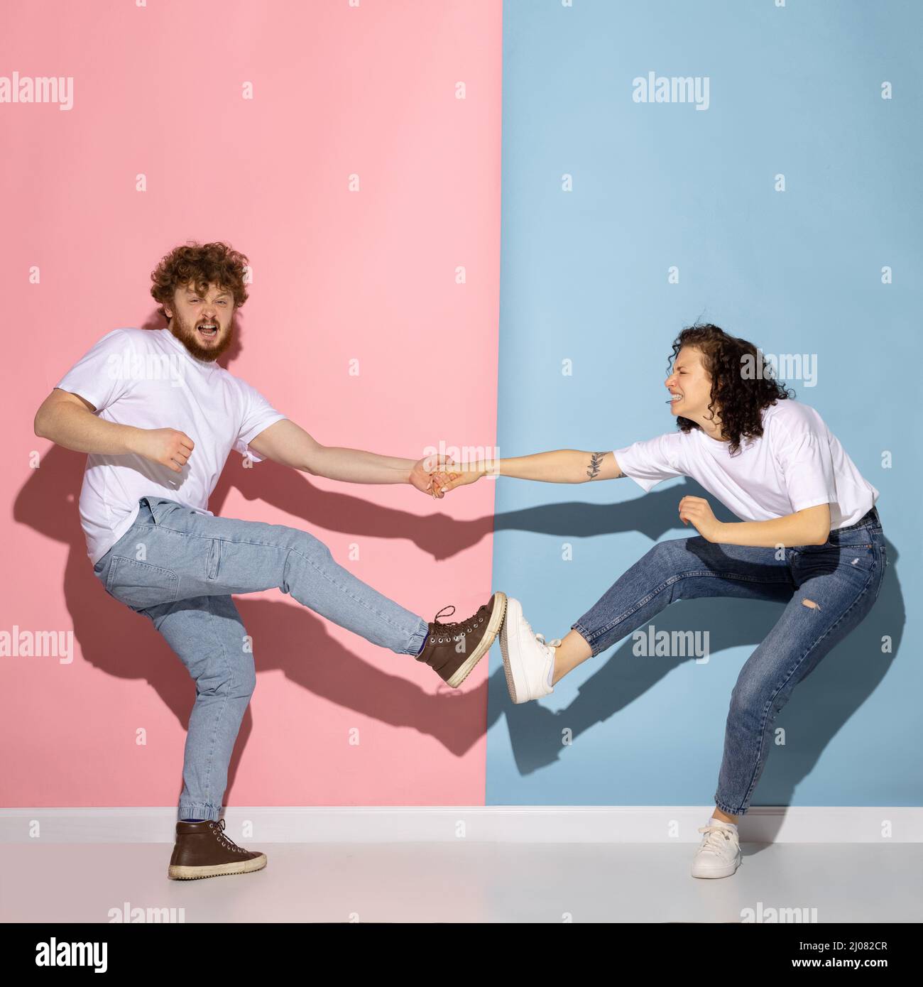Married couple, young emotive man and girl isolated on blue and pink ...