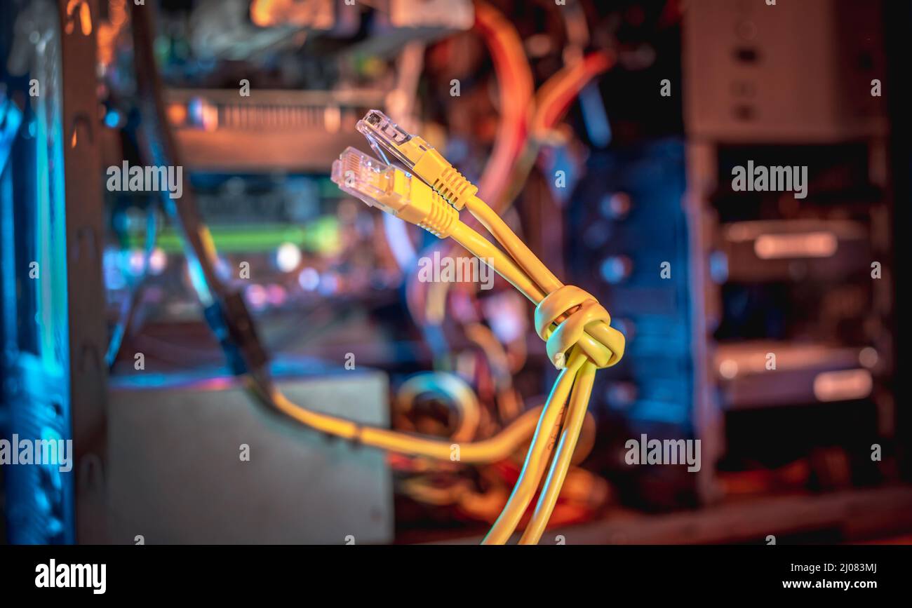 The hand holds the Internet cable tied in a knot. The concept of ...