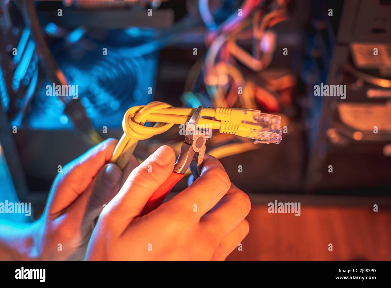 Cutting the Internet cable tied into a knot with wire cutters. The ...