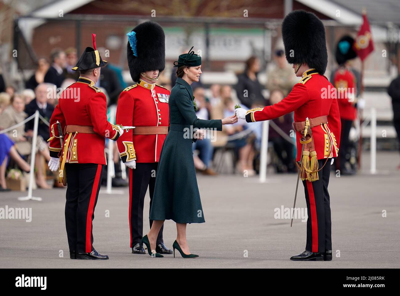 The Duchess of Cambridge hands sprigs of shamrock to an officer during ...