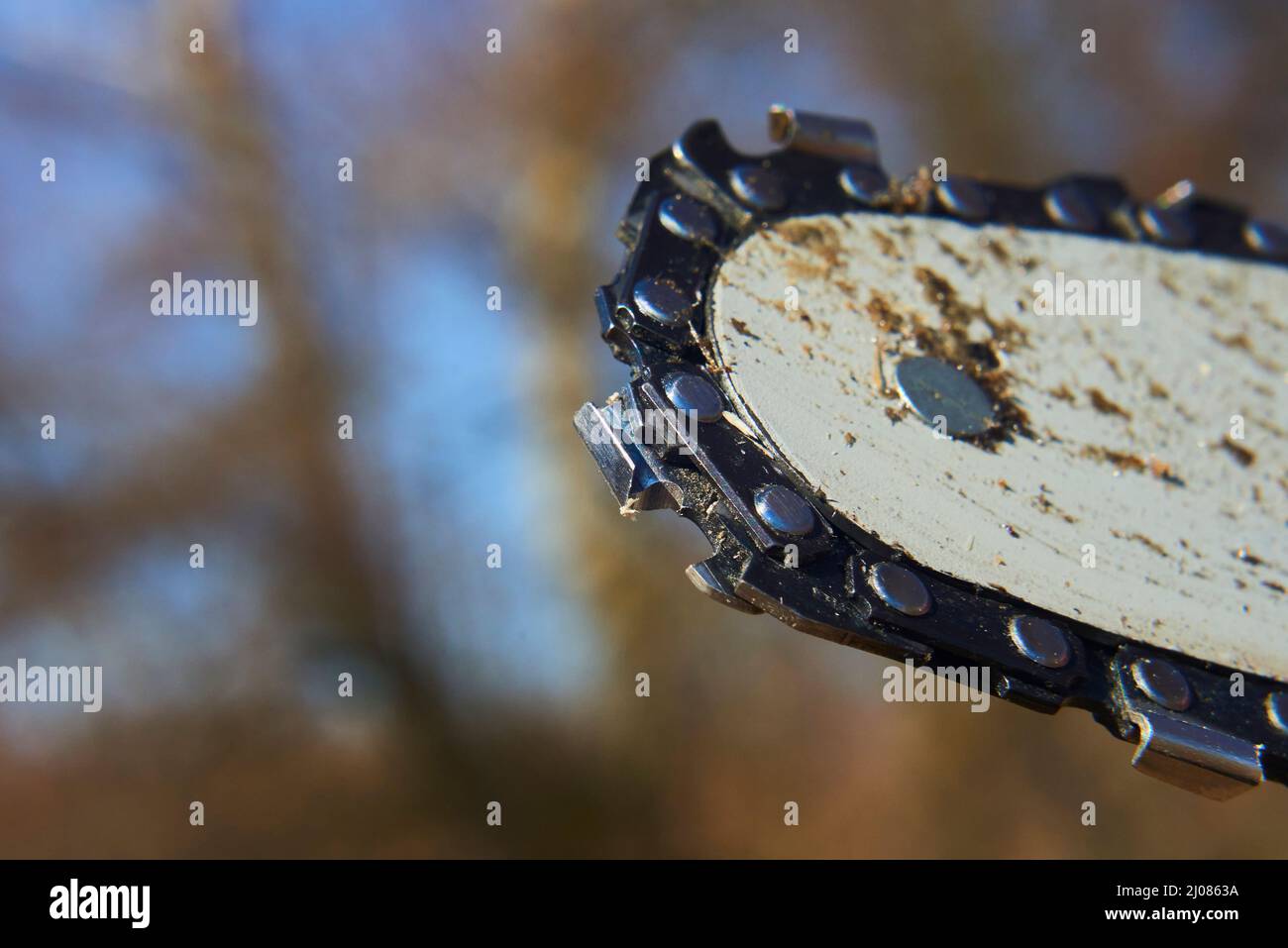 Detail of dirty used chainsaw chain for cutting wood. Selective focus ...