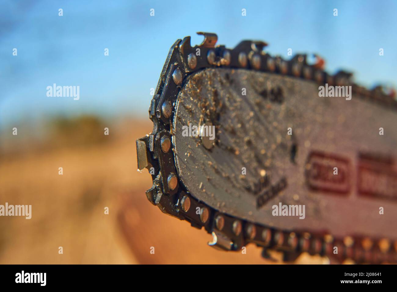 Detail of dirty used chainsaw chain for cutting wood. Selective focus ...