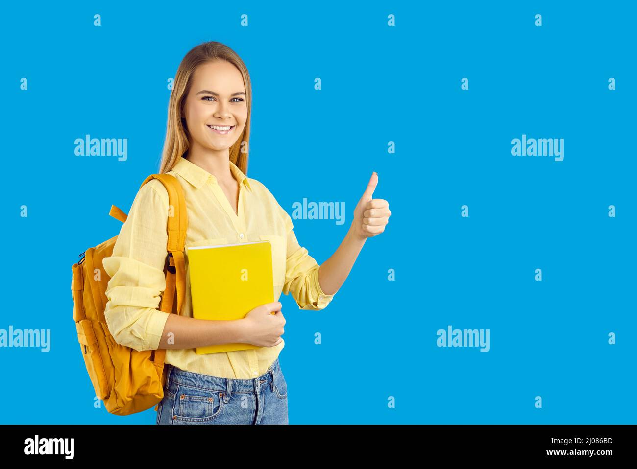 Happy successful university student with book and backpack smiling and ...