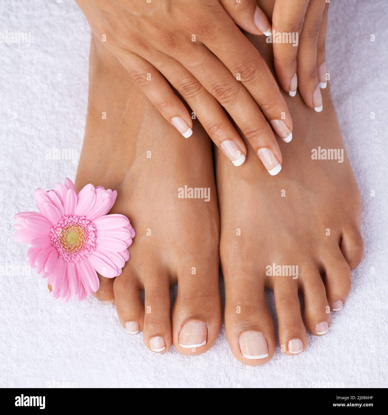 Foot massage. Cropped view of hands on perfectly pedicured feet with ...