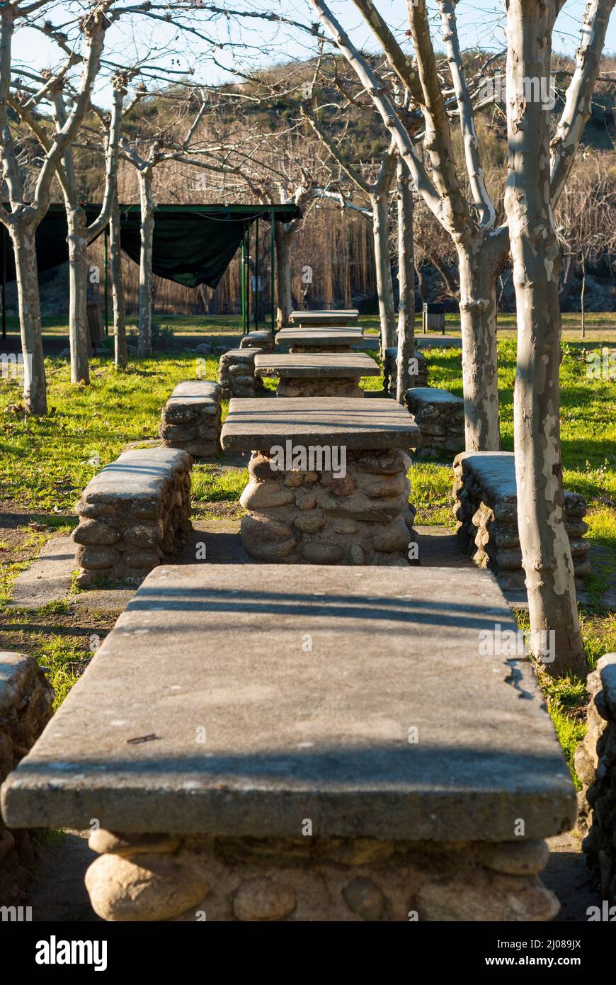 Outdoor picnic area, stone tables in a row in an area of trees, Abadia ...
