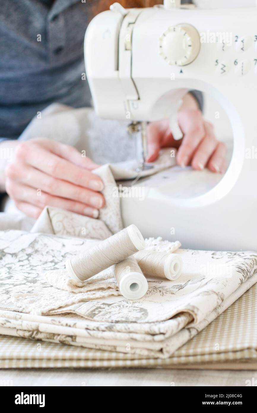 Woman using sewing machine. Hobby time Stock Photo - Alamy