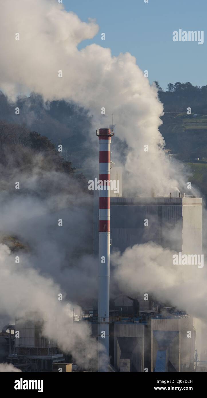 Fumes and pollution in factory chimneys Stock Photo - Alamy
