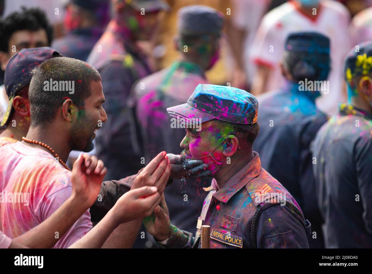People smear vermilion powder on the face of a Nepal police officer on ...