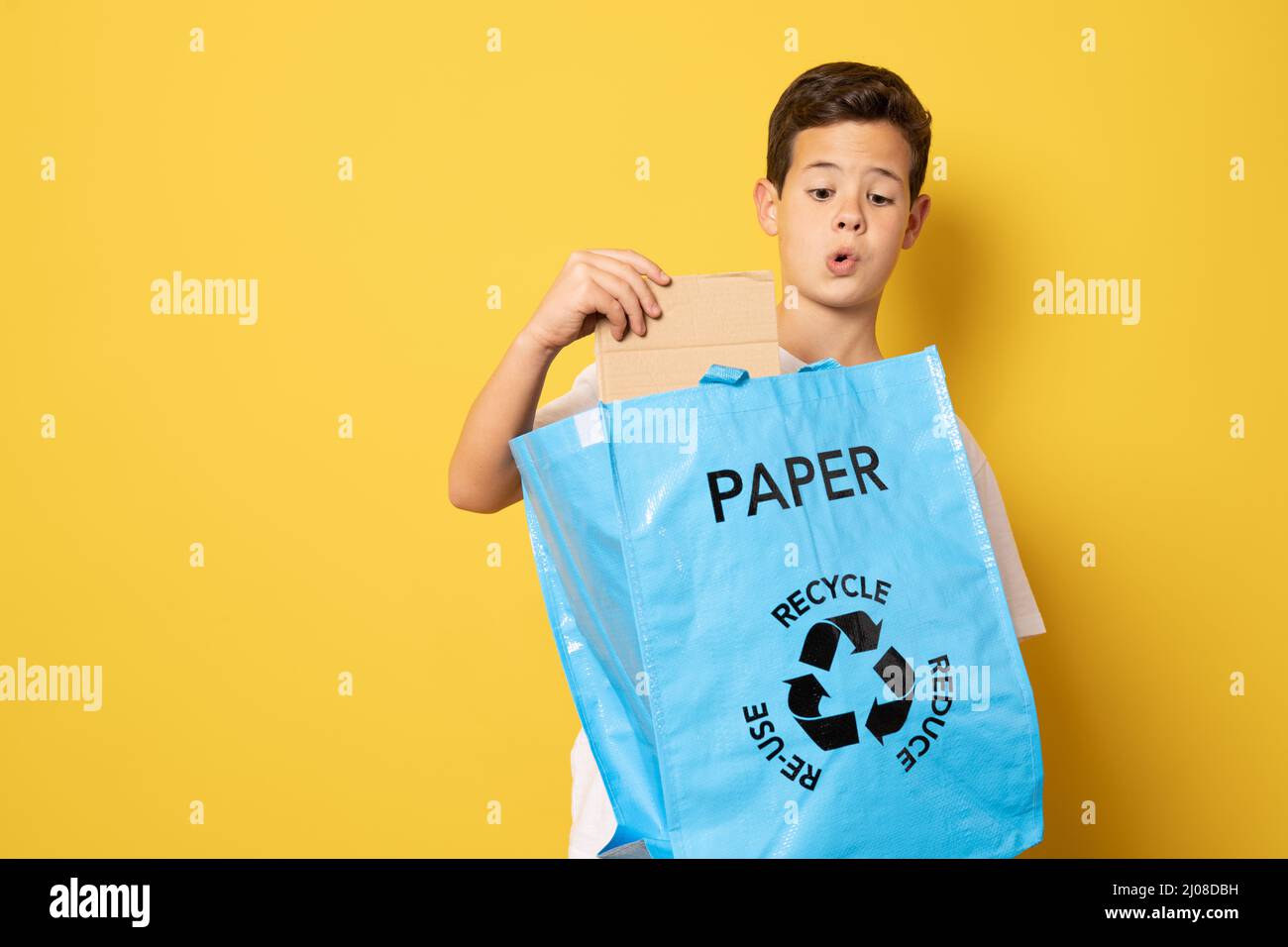 Child boy holding and sorting of paper in the recycling box for ...