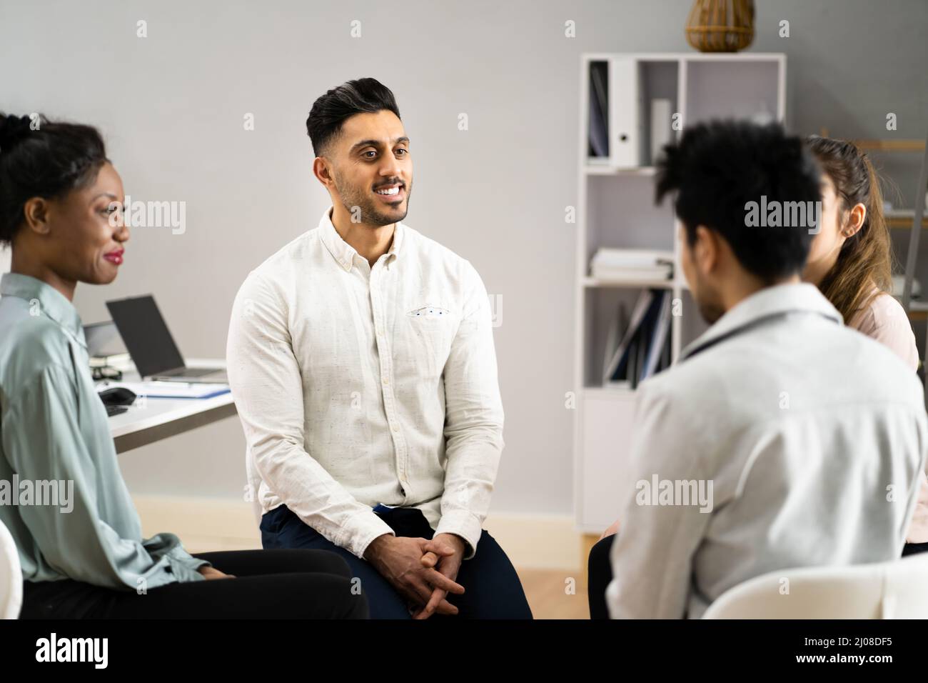 Young Multiracial Millennial Friends Sitting In Circle Having Group ...