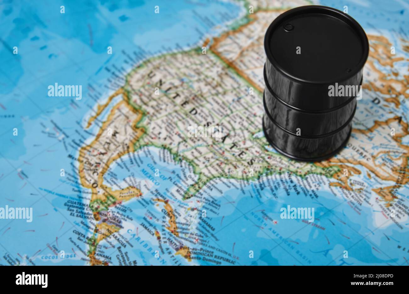 Oil drum with crude petroleum standing on a map Stock Photo - Alamy
