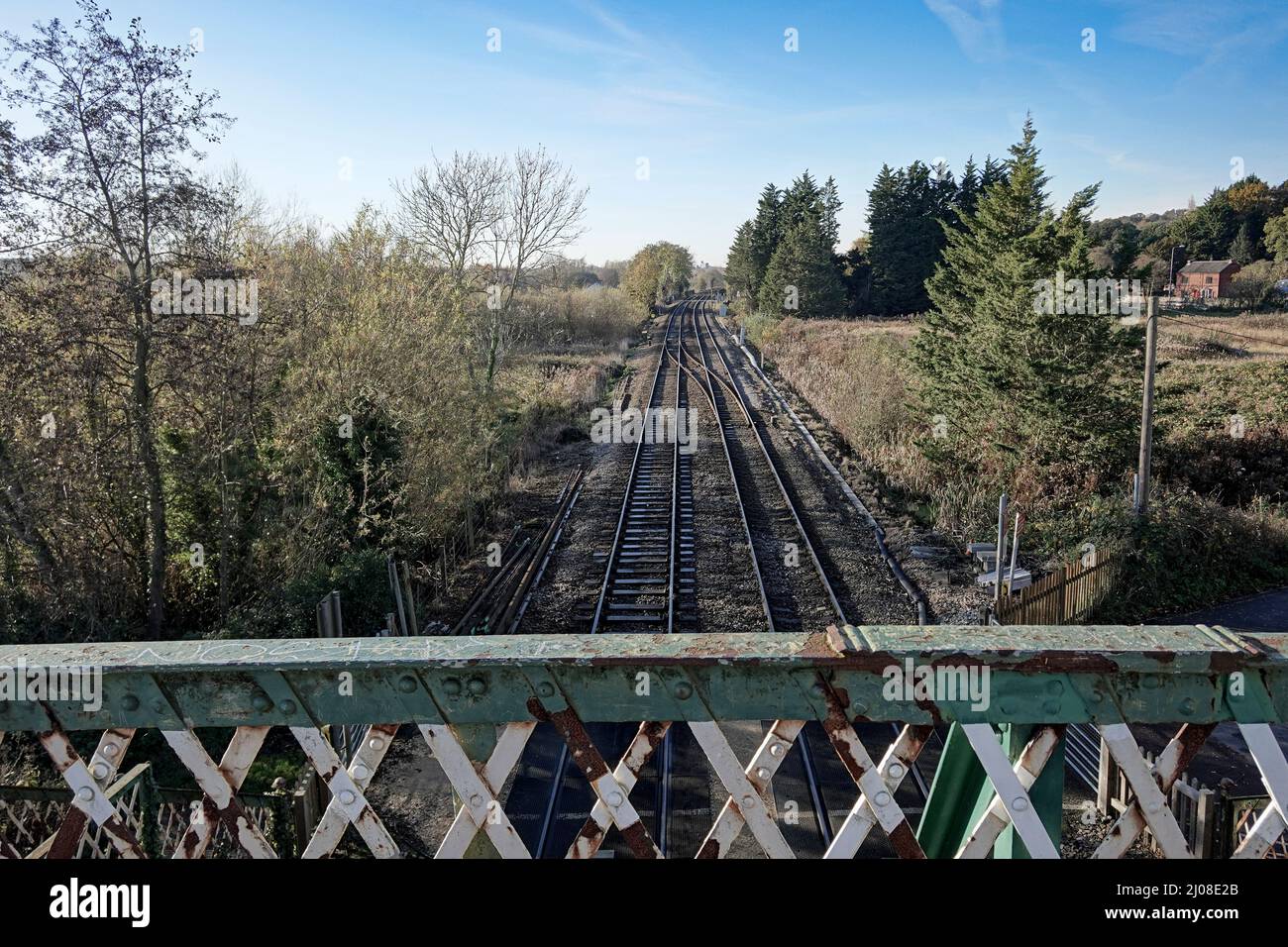 Railway line viewed from traditional metal rail footbridge Stock Photo ...