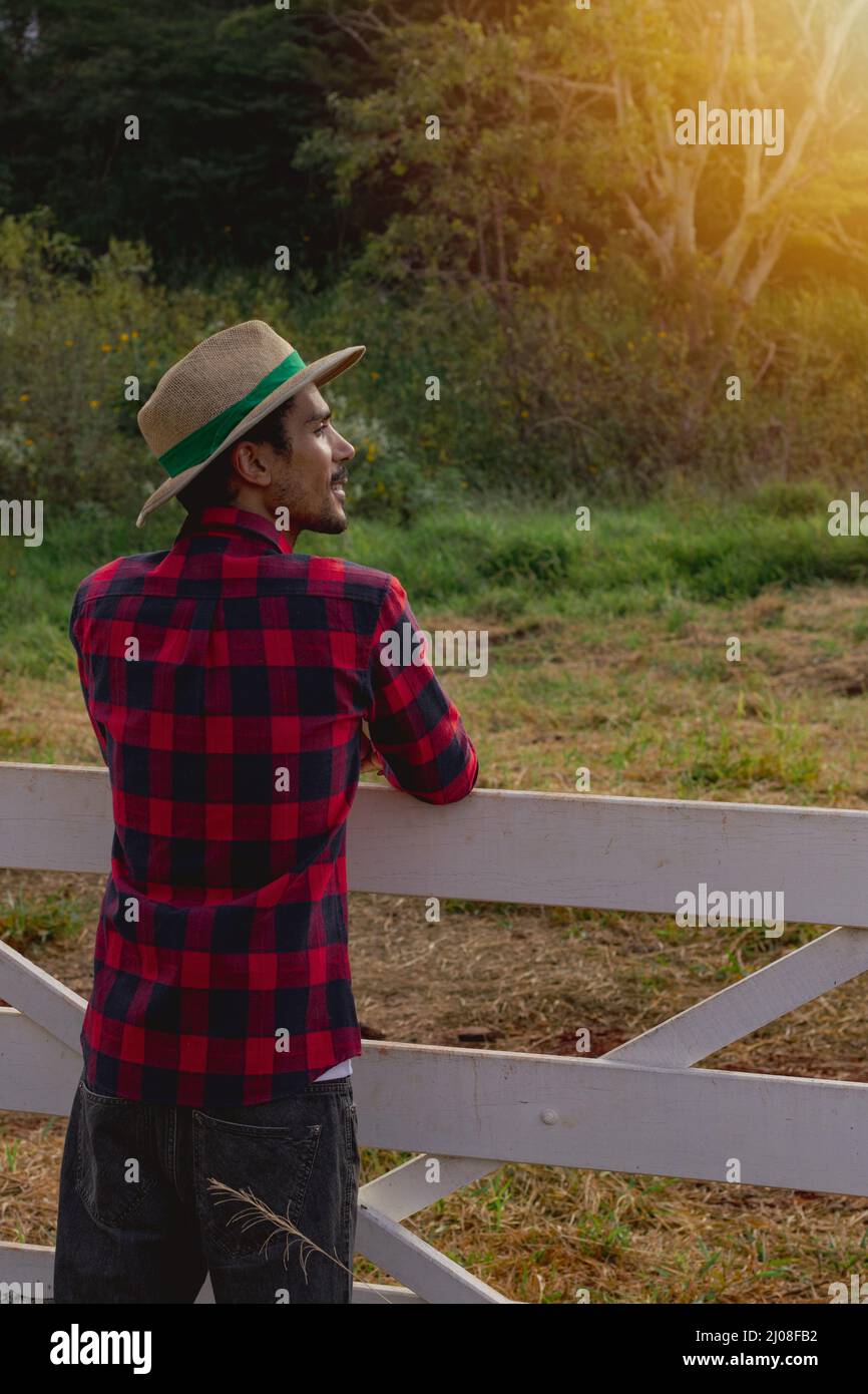 Male young black farmer working in front of the farmers gate Stock ...