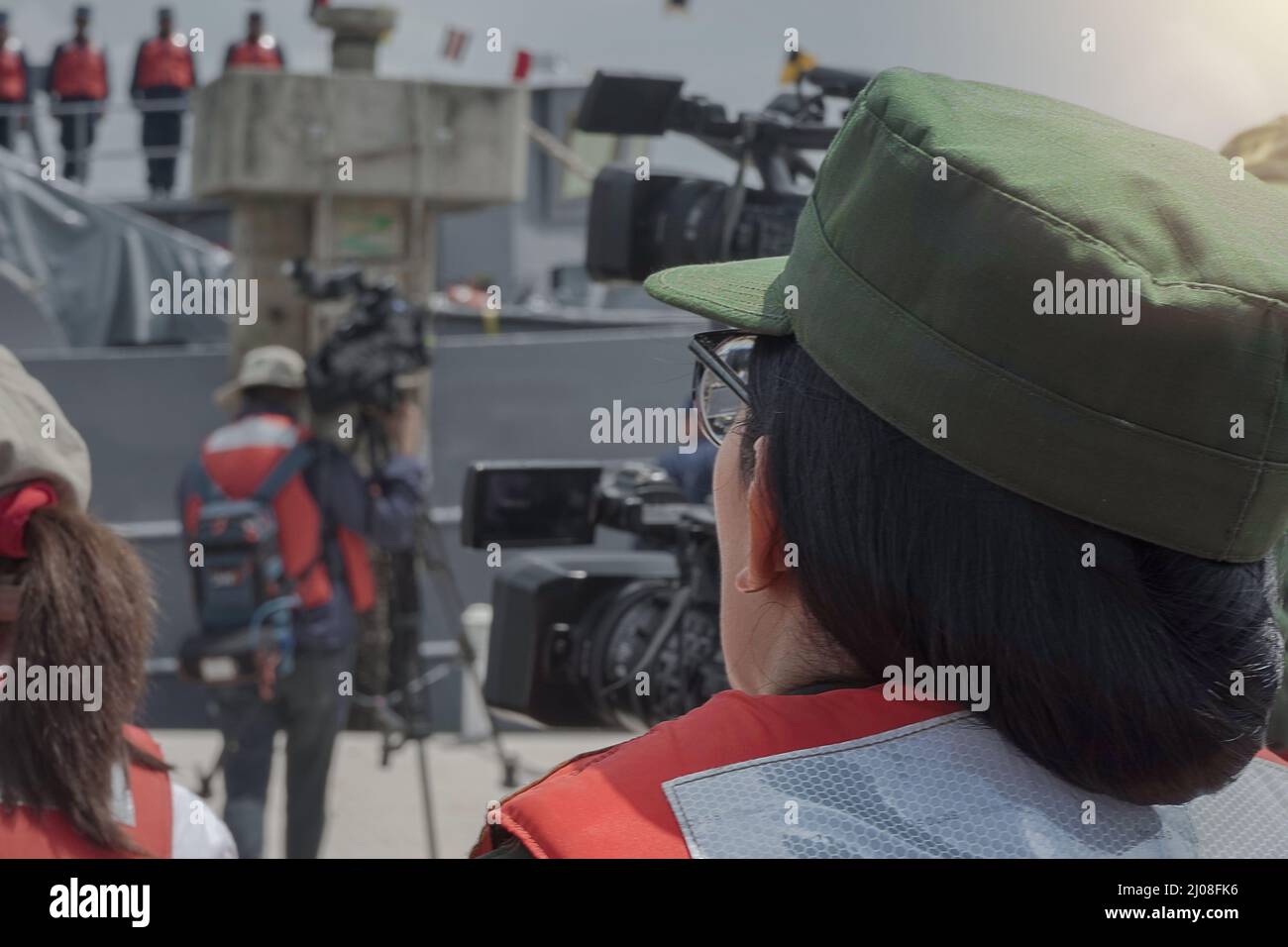 Woman military journalist in front of a combat ship gives press ...